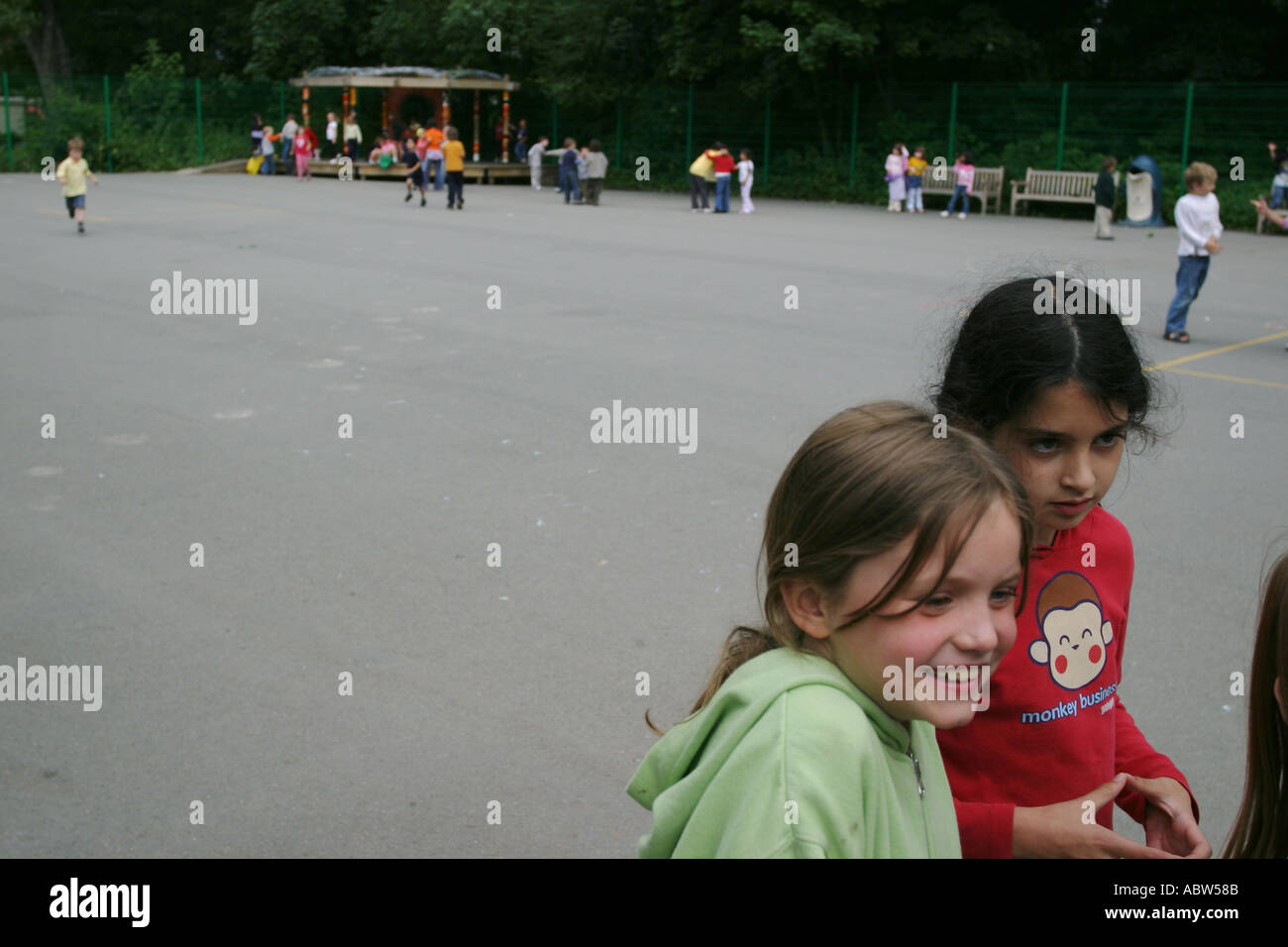 Two friends playing together and laughing in the playground, Betty ...