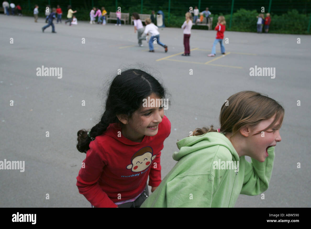 Two friends playing together and laughing in the playground, Betty ...