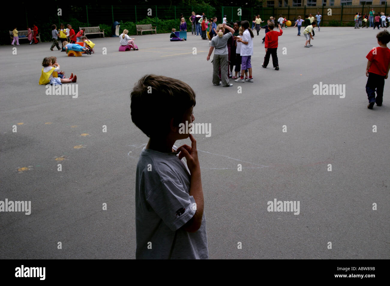 A child alone in a school playground, London Junior School Stock Photo ...