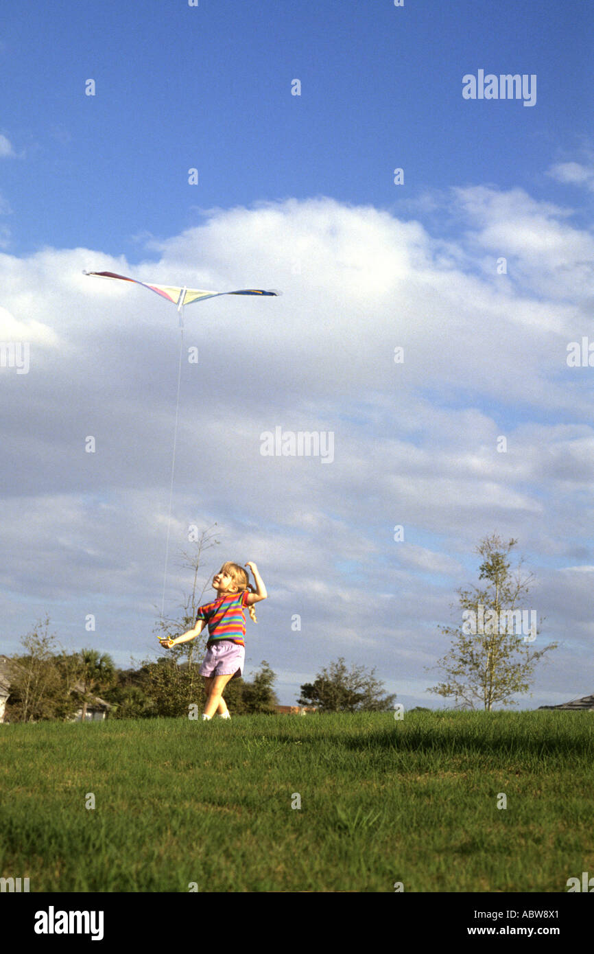 Kid fly kite up in sky hi-res stock photography and images - Alamy