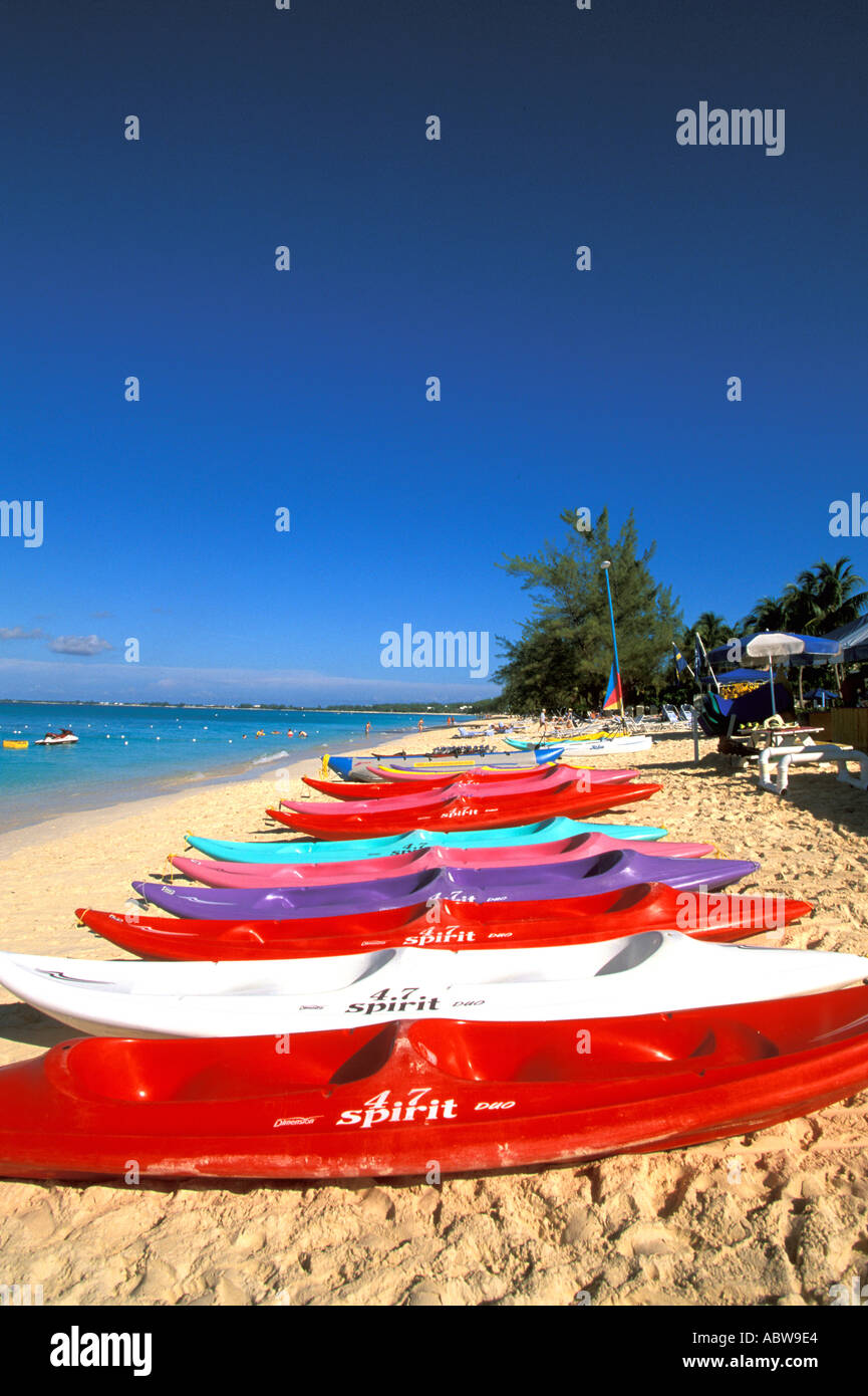 Caribbean Grand Cayman Seven Mile Beach kayaks in a row vertical Stock ...