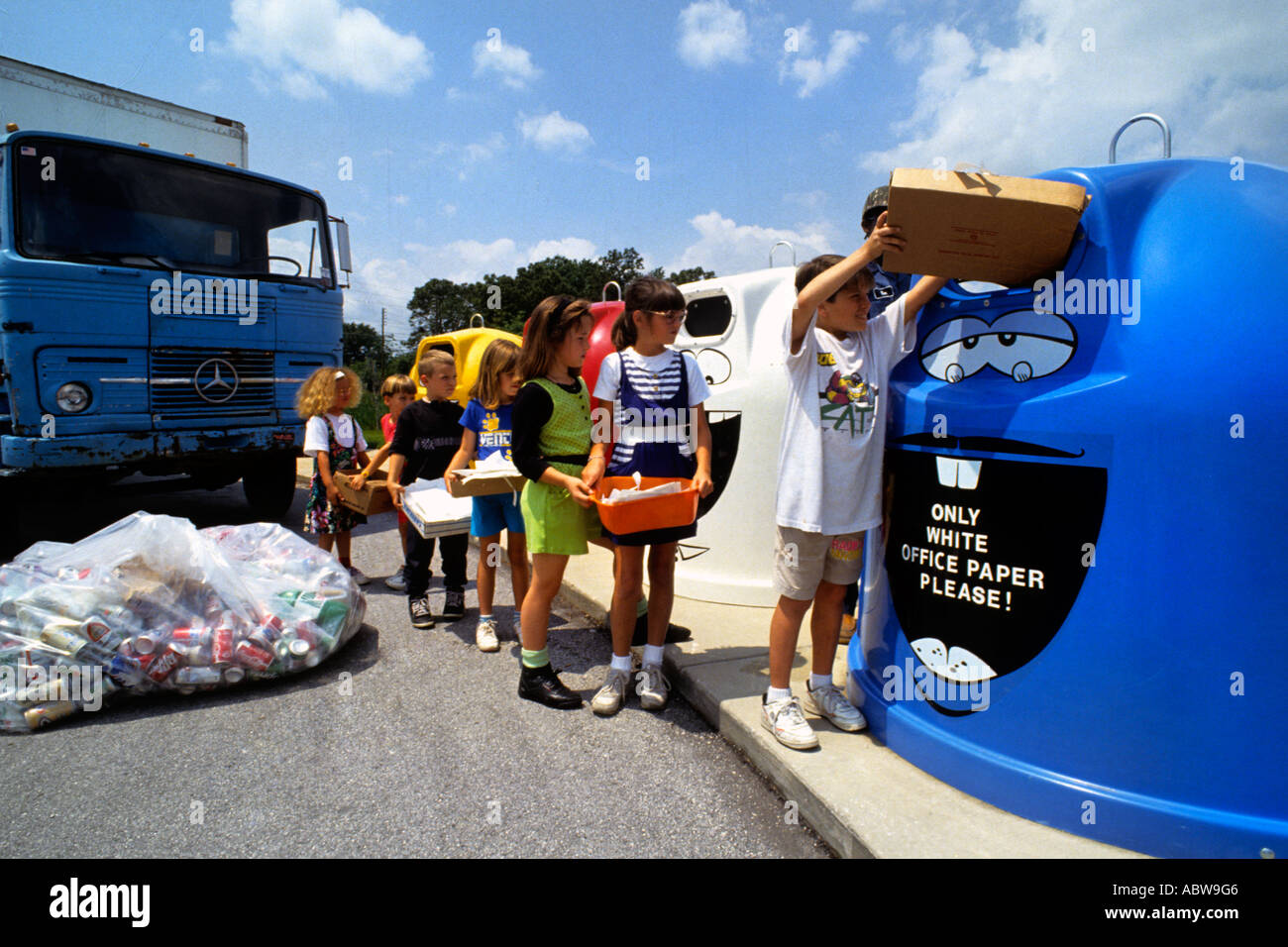 Environment Children bringing cans and cardboard to be recycled at ...