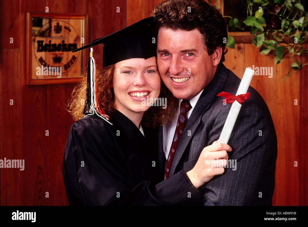 Student graduating from high school with celebration at home with ...