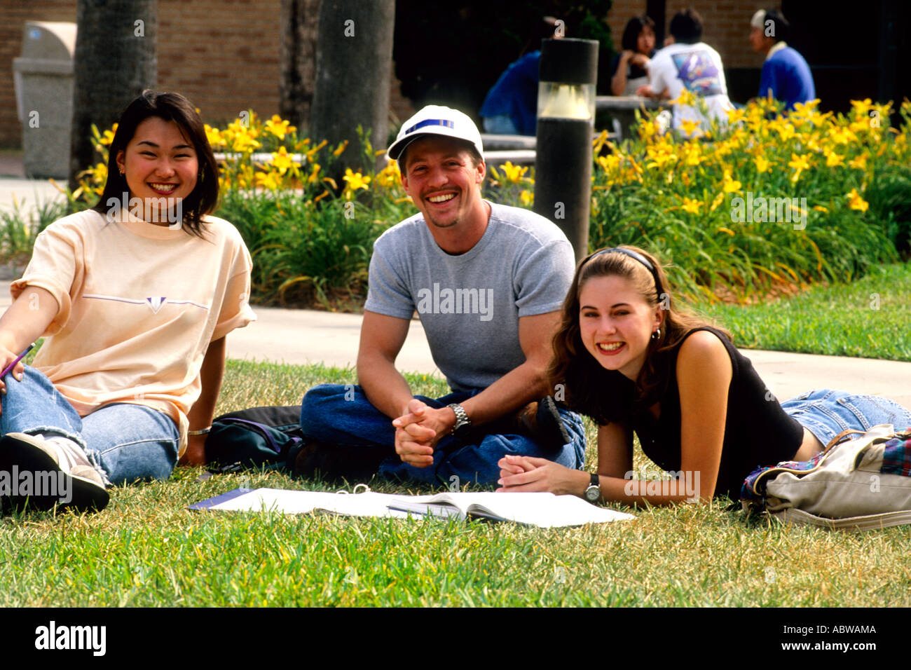 College students outside relaxing before going to class Stock Photo - Alamy