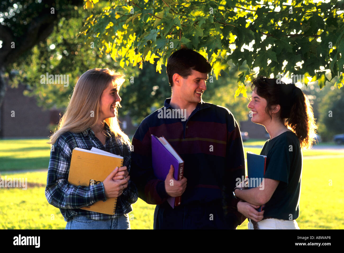 College students outside relaxing before going to class Stock Photo - Alamy
