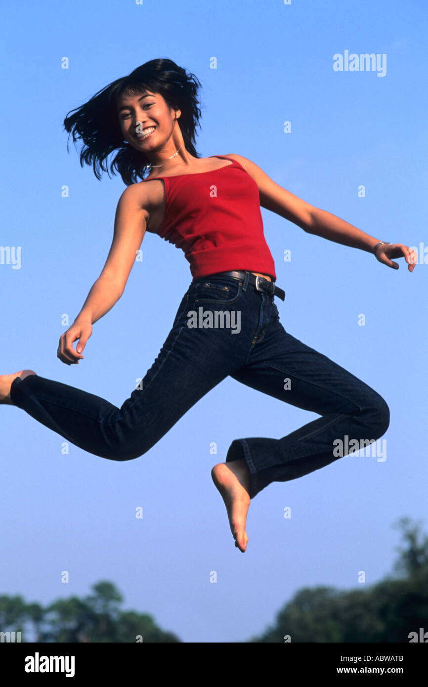 Teenage girl leaping in air with joy and action towards the future ...