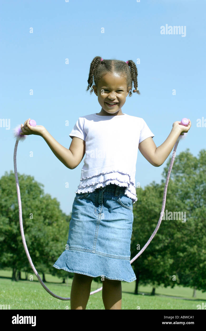 Girl playing with skipping rope hi-res stock photography and images - Alamy