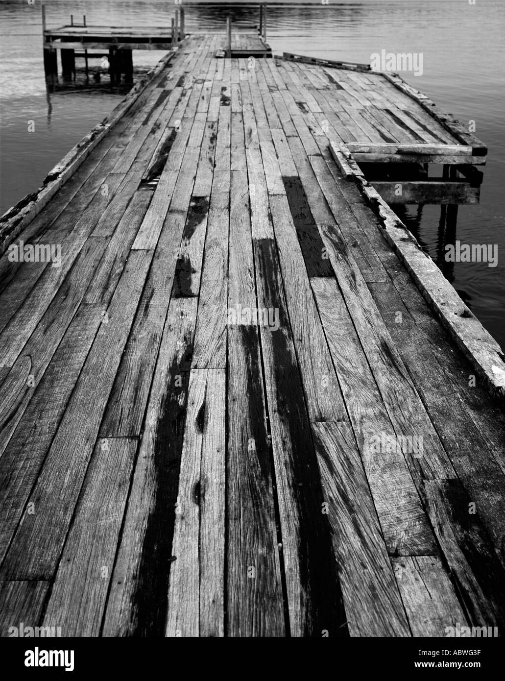 An old wooden jetty leading out into the sea Stock Photo - Alamy