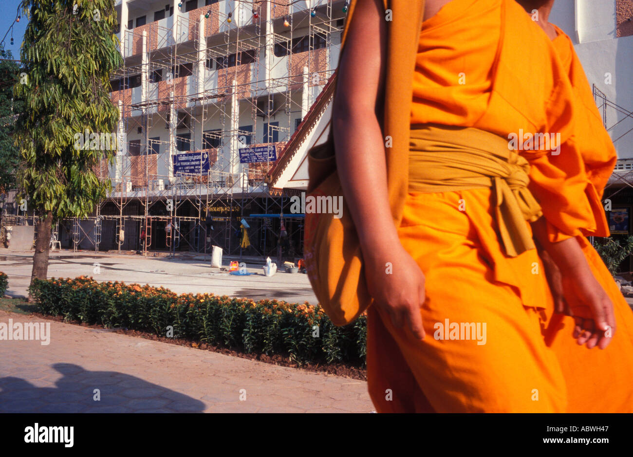 Buddhist monks walk past a new construction project Vientiane Laos ...