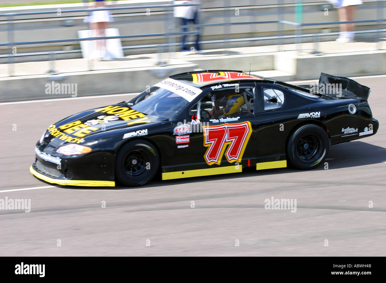 V8 Nascar type stock cars racing on a banked oval circuit Stock Photo ...