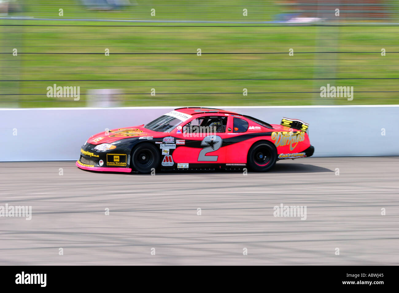 V8 Nascar type stock cars racing on a banked oval circuit Stock Photo ...