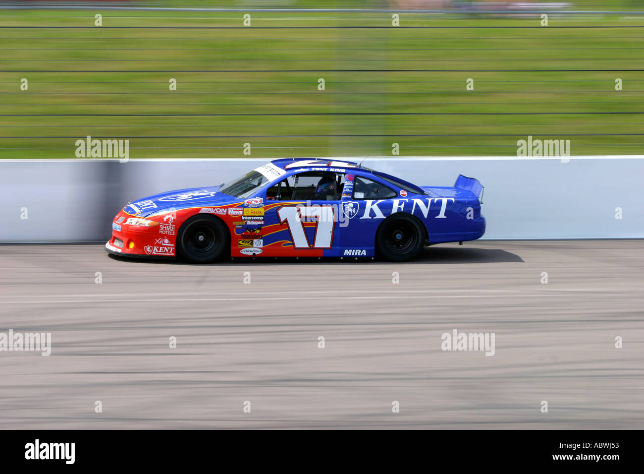 V8 Nascar type stock cars racing on a banked oval circuit Stock Photo ...