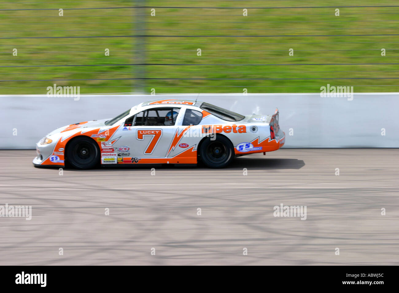 V8 Nascar type stock cars racing on a banked oval circuit Stock Photo ...