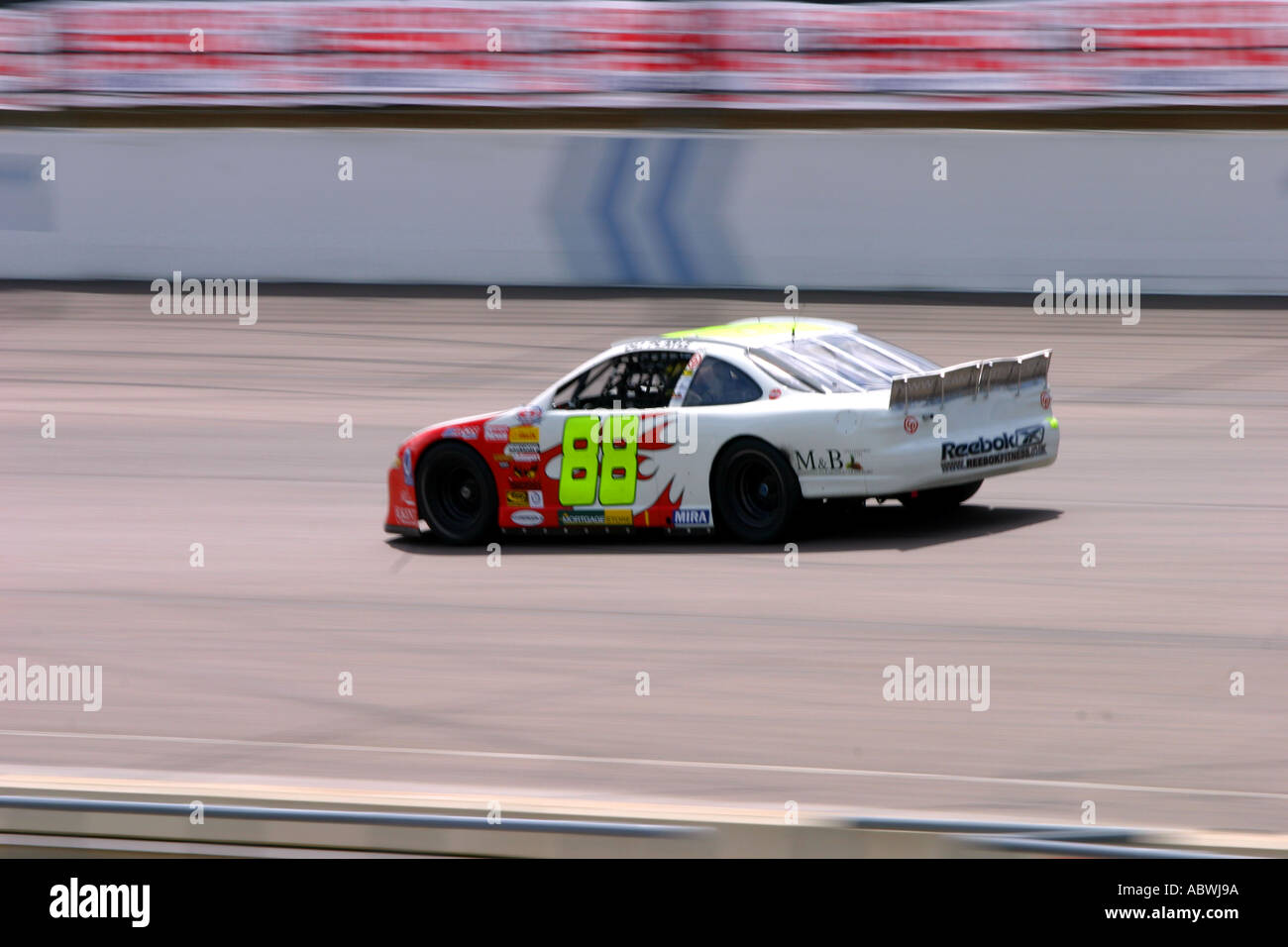 V8 Nascar type stock cars racing on a banked oval circuit Stock Photo ...