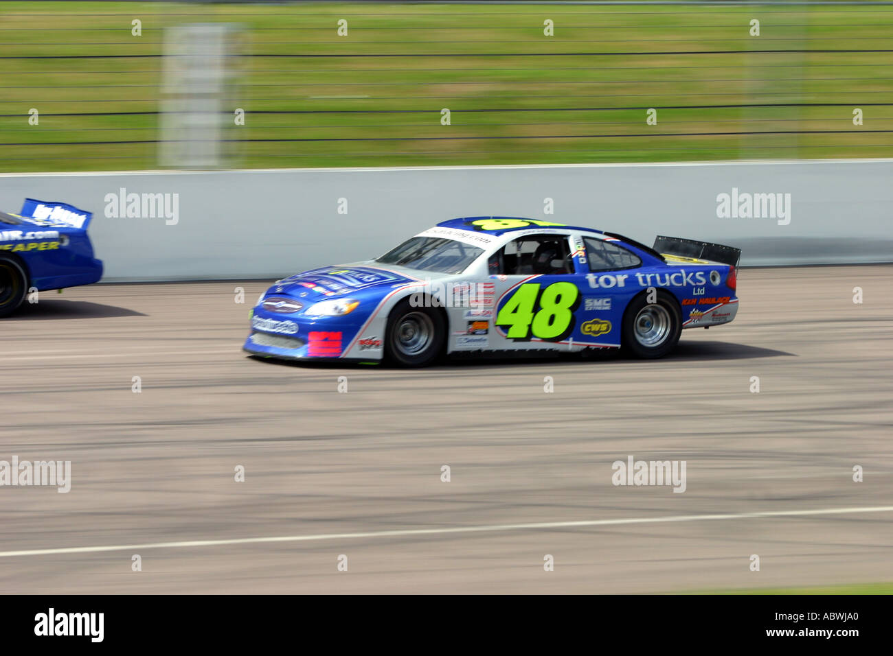 V8 Nascar type stock cars racing on a banked oval circuit Stock Photo ...