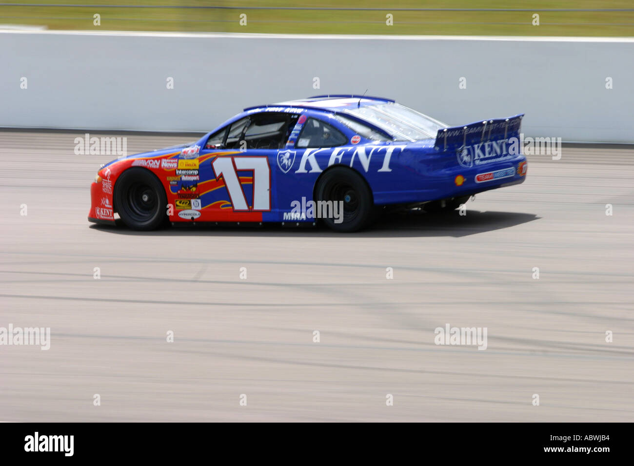 V8 Nascar type stock cars racing on a banked oval circuit Stock Photo ...