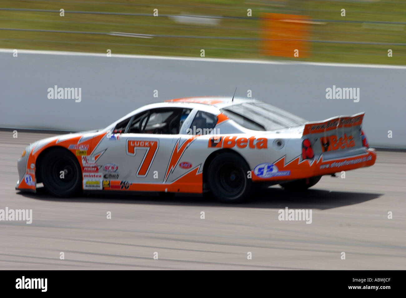 V8 Nascar type stock cars racing on a banked oval circuit Stock Photo ...