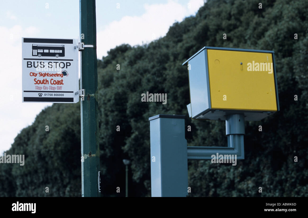 A bus stop sign next to a speed camera Stock Photo - Alamy