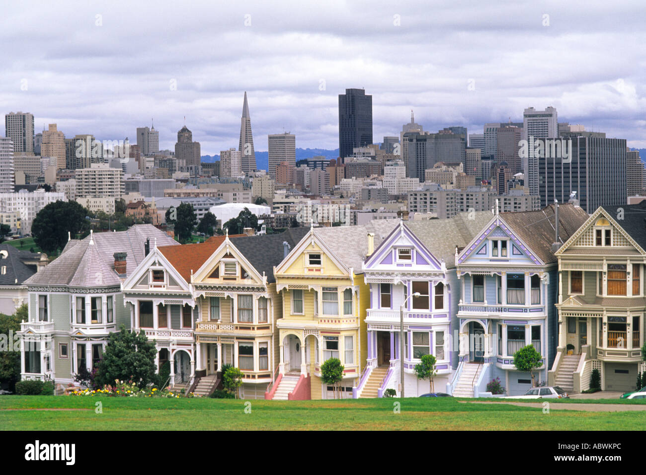 Famous Victorian House row and skyline with Transamerica Building in ...