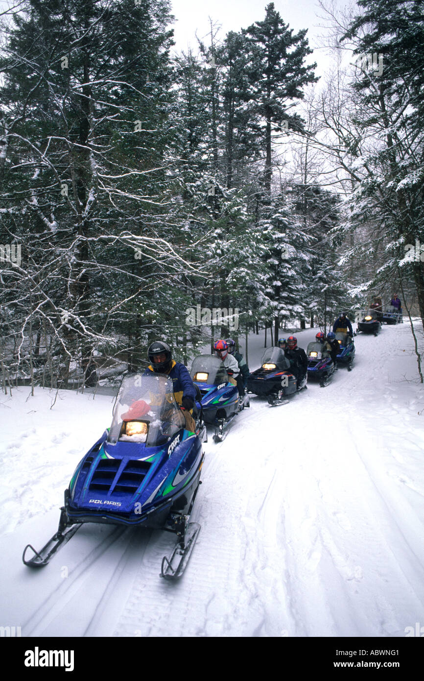 Snow mobiling adventure with riders thru the winter trails in New ...