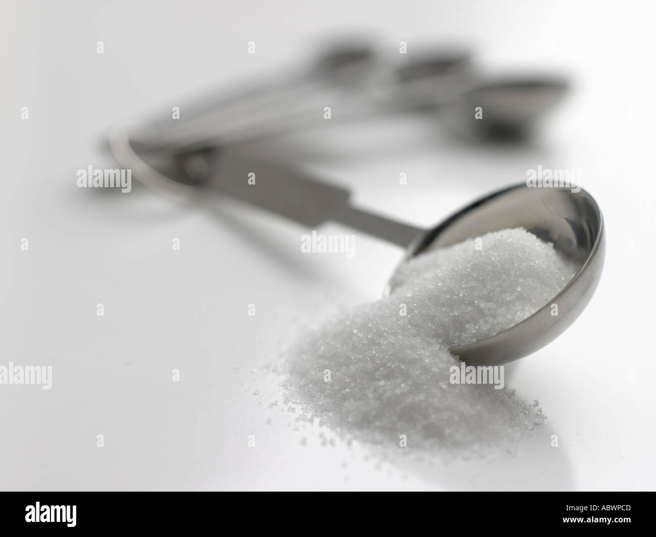 white sugar and measuring spoons Stock Photo - Alamy