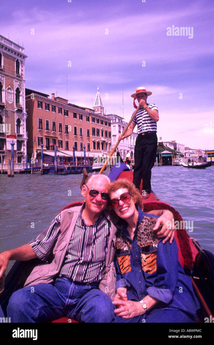 Retired happy Tourists celebrating on romantic gondola ride on canal ...