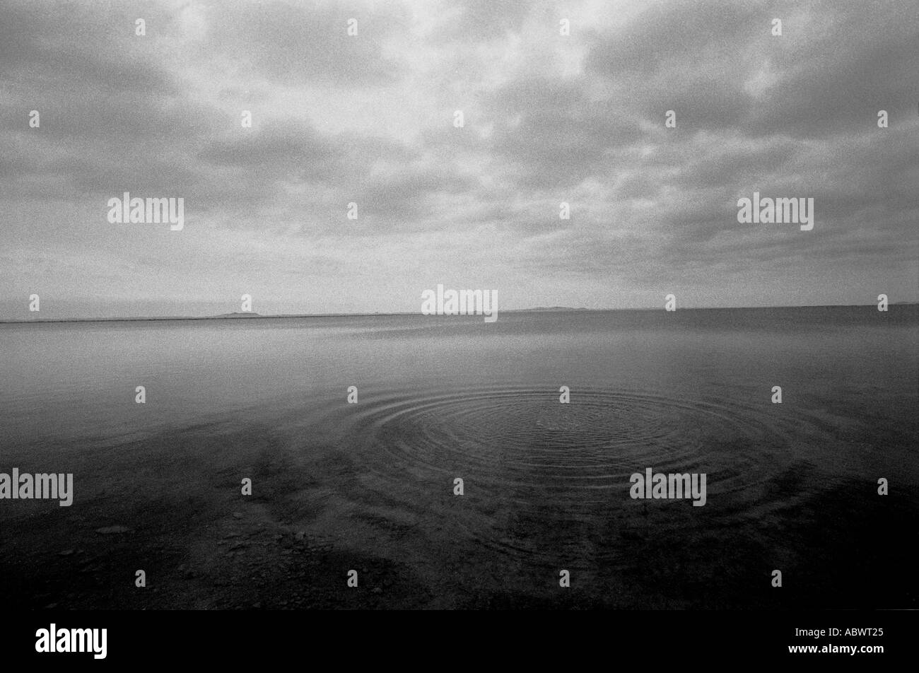 a stone thrown to the water 3 Stock Photo - Alamy