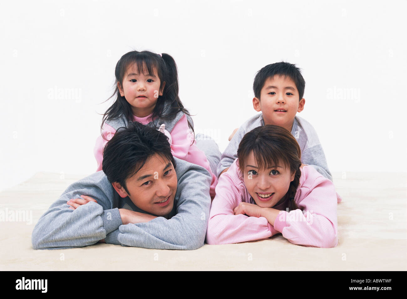 Two children resting on their parents back Stock Photo - Alamy