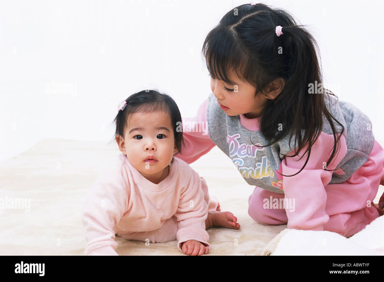 A girl looking after a baby Stock Photo - Alamy