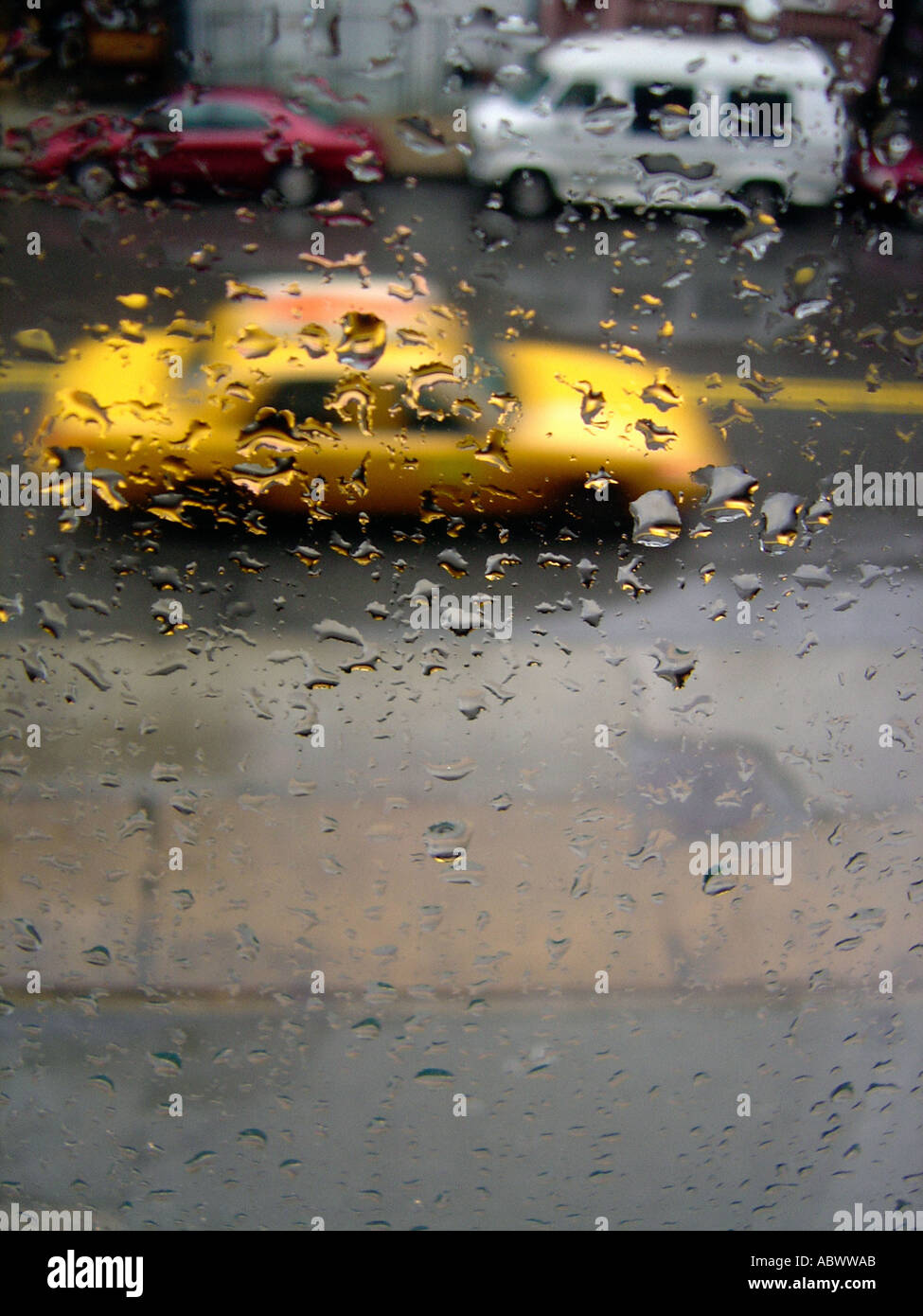 Urban Scene of a Yellow Taxi Cab Viewed Through A Window That is Wet ...