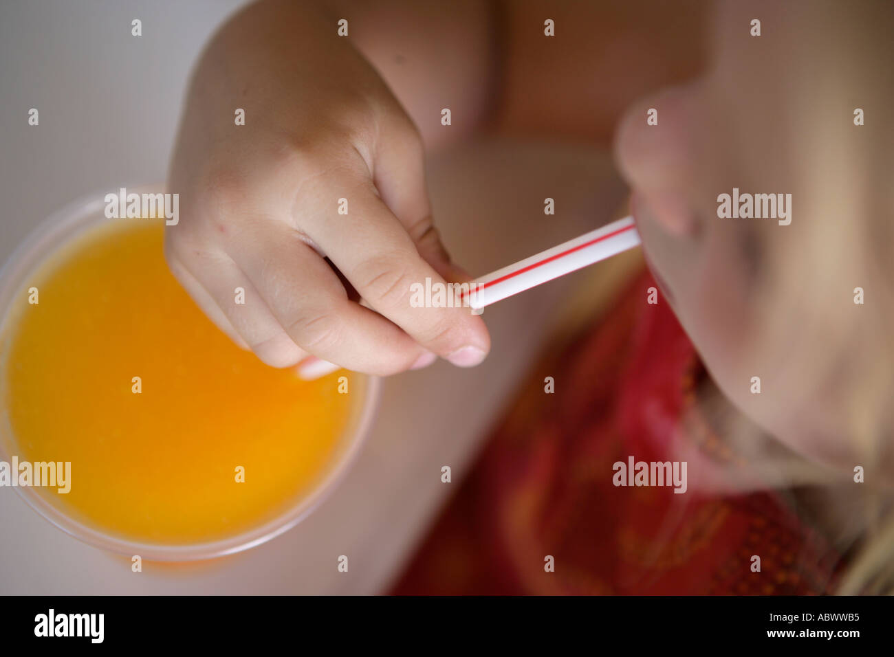 Little blonde girl drinking orange hi-res stock photography and images ...