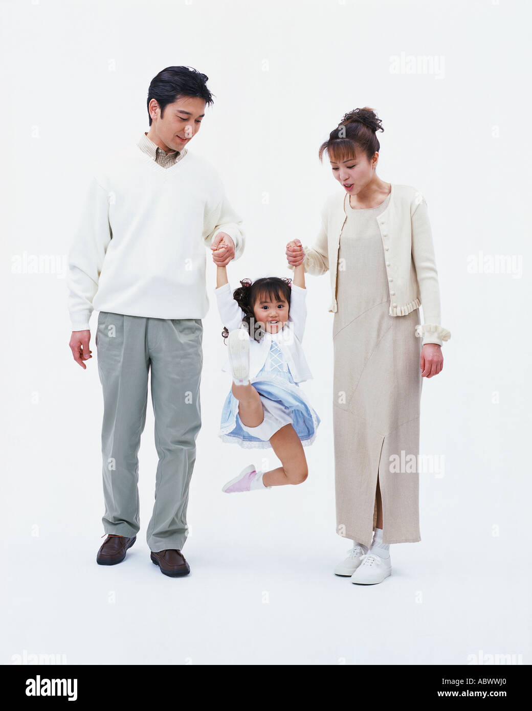 Parents lifting their daughter Stock Photo - Alamy