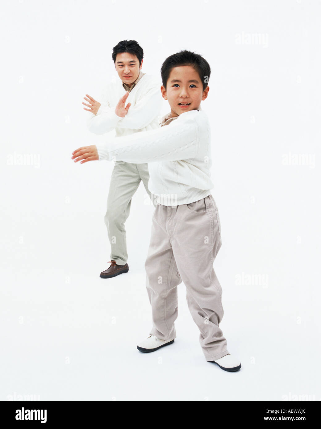 A boy posing with his father Stock Photo - Alamy