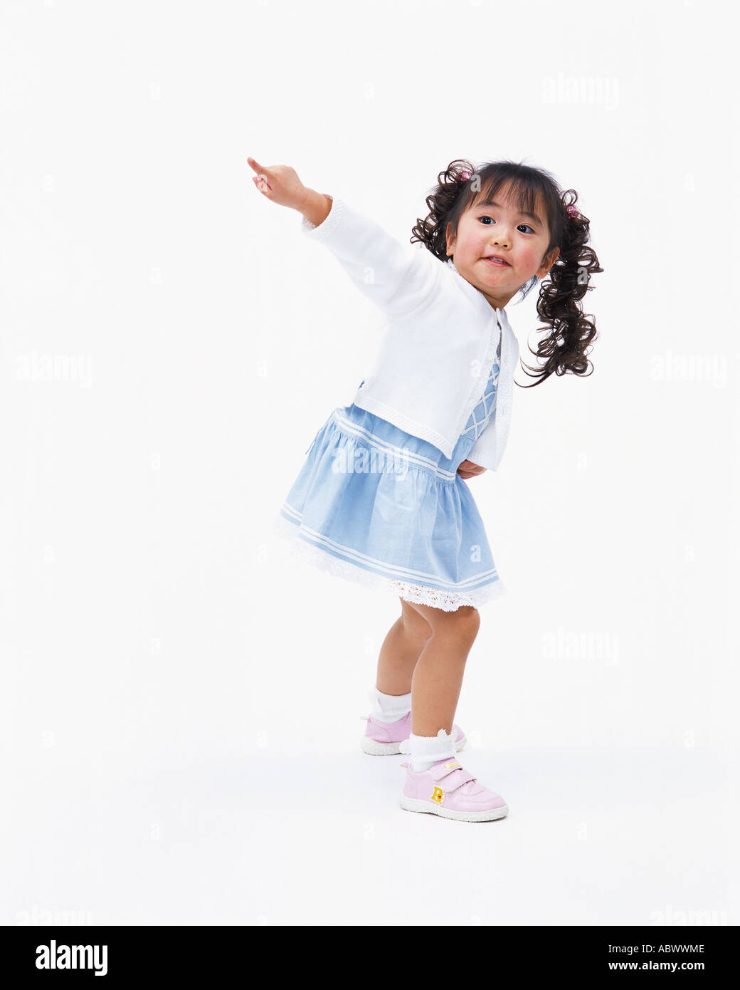 A girl pointing at a direction Stock Photo - Alamy