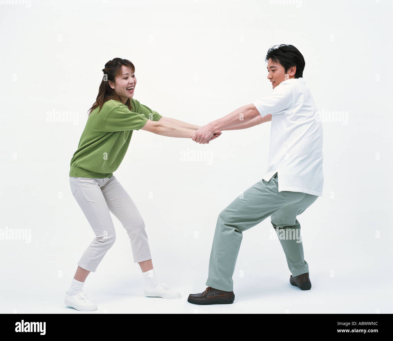 Side view of a woman pulling her husband s hand Stock Photo - Alamy