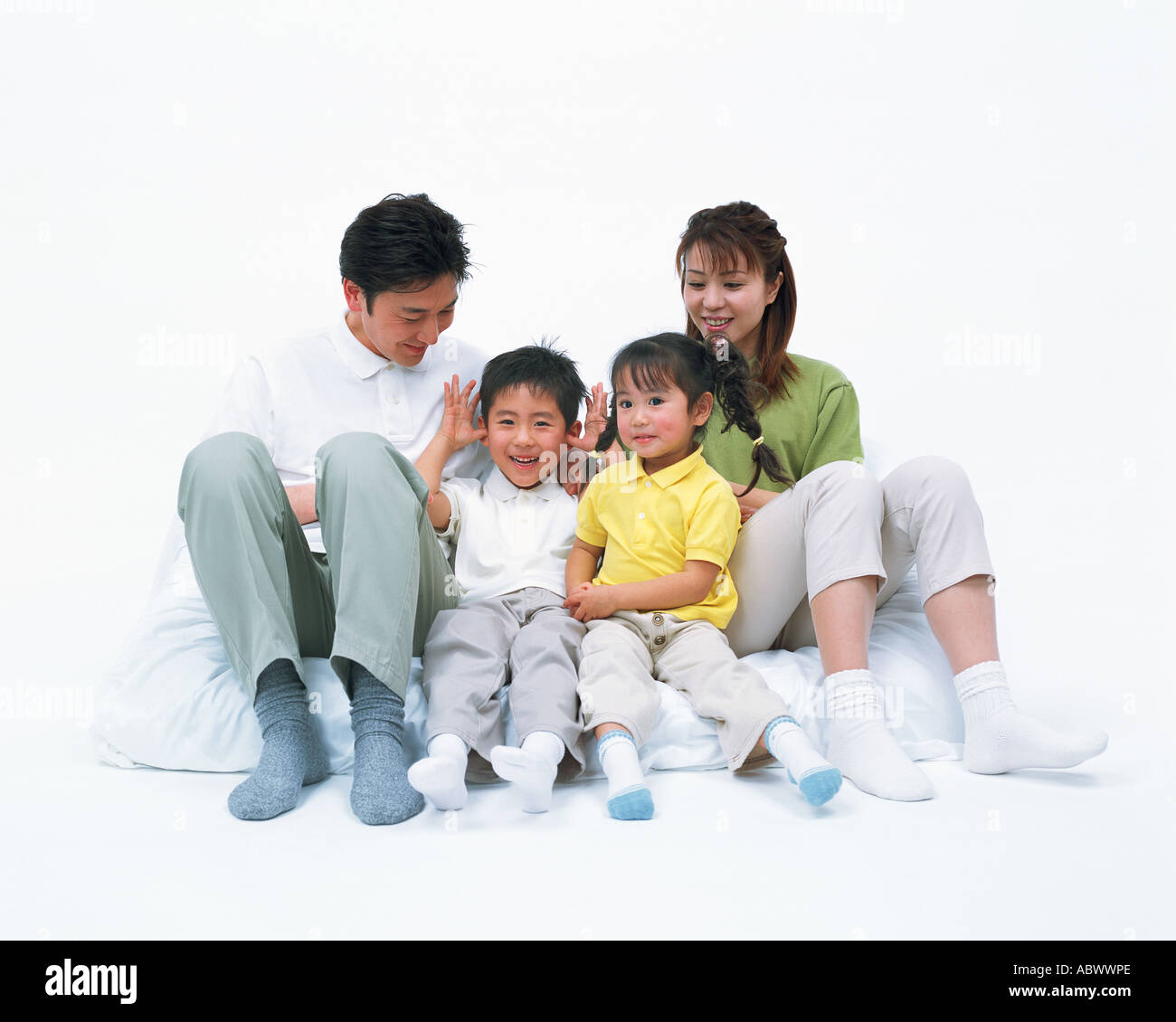 A happy family resting on mattress Stock Photo - Alamy