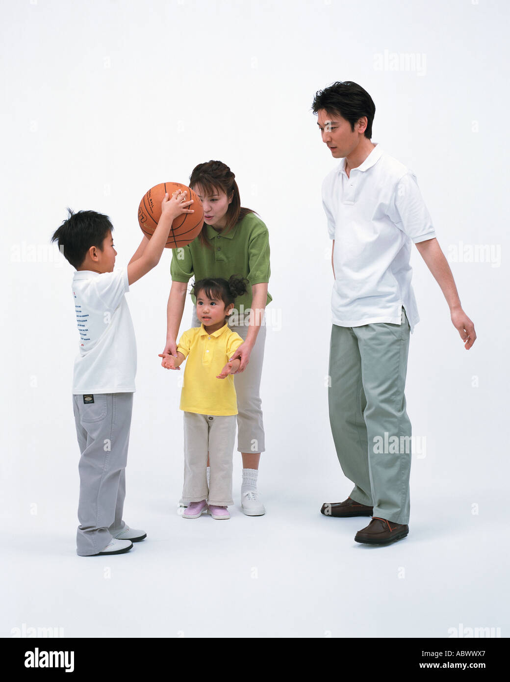 A family playing with a basketball Stock Photo - Alamy
