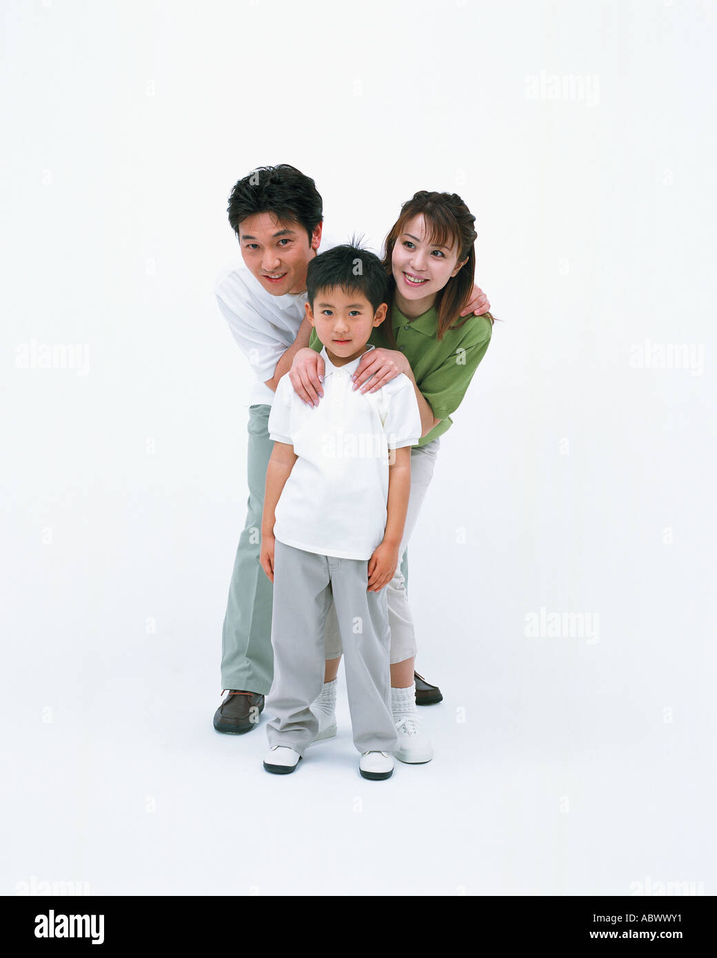 A boy looking at camera with his parents standing behind him Stock ...