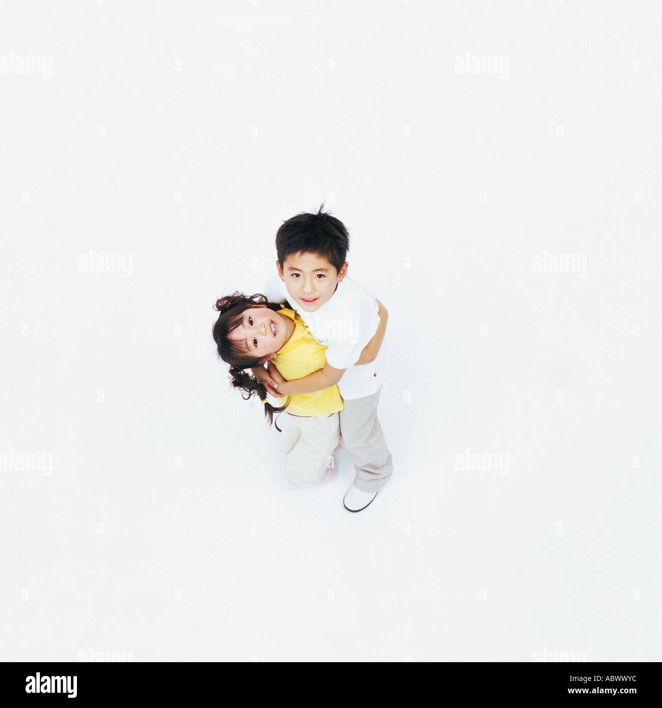 High angle view of two children hugging each other Stock Photo - Alamy