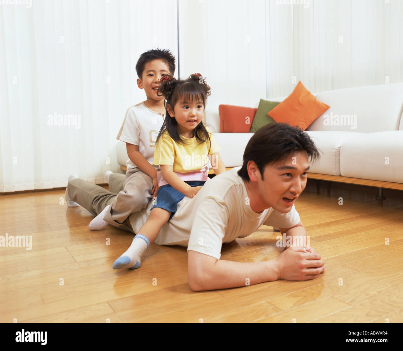 Two children sitting on their father s back Stock Photo - Alamy