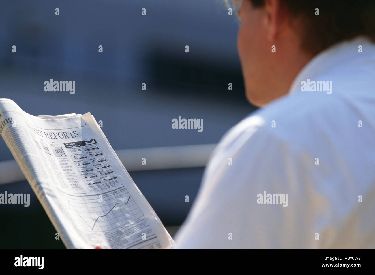 Side view of a person reading newspaper Stock Photo - Alamy