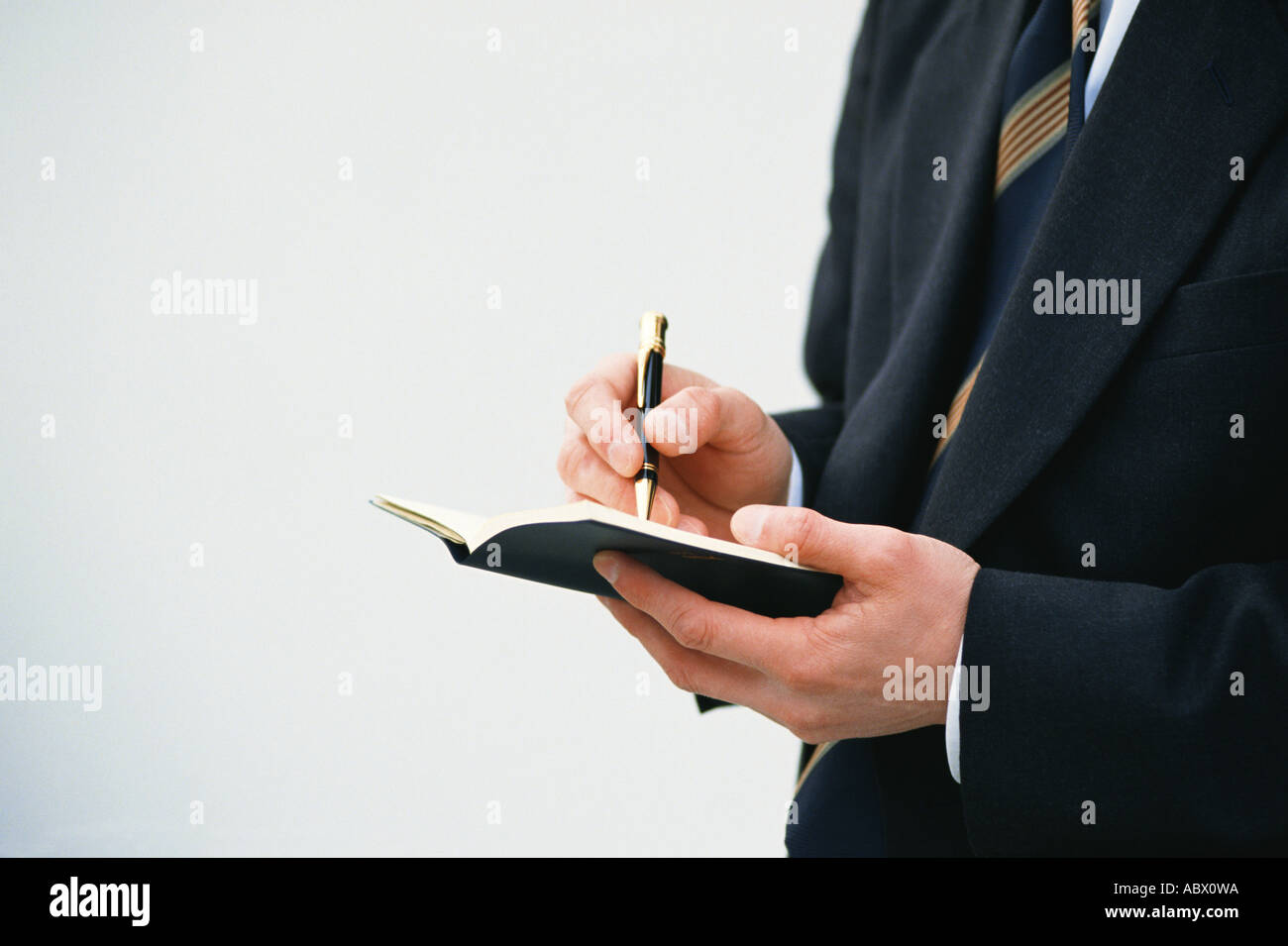 A businessman taking down notes in his personal diary Stock Photo - Alamy
