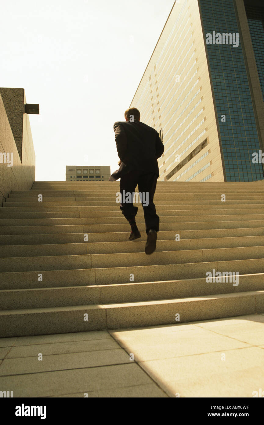 Rear view of a man walking up steps hi-res stock photography and images ...