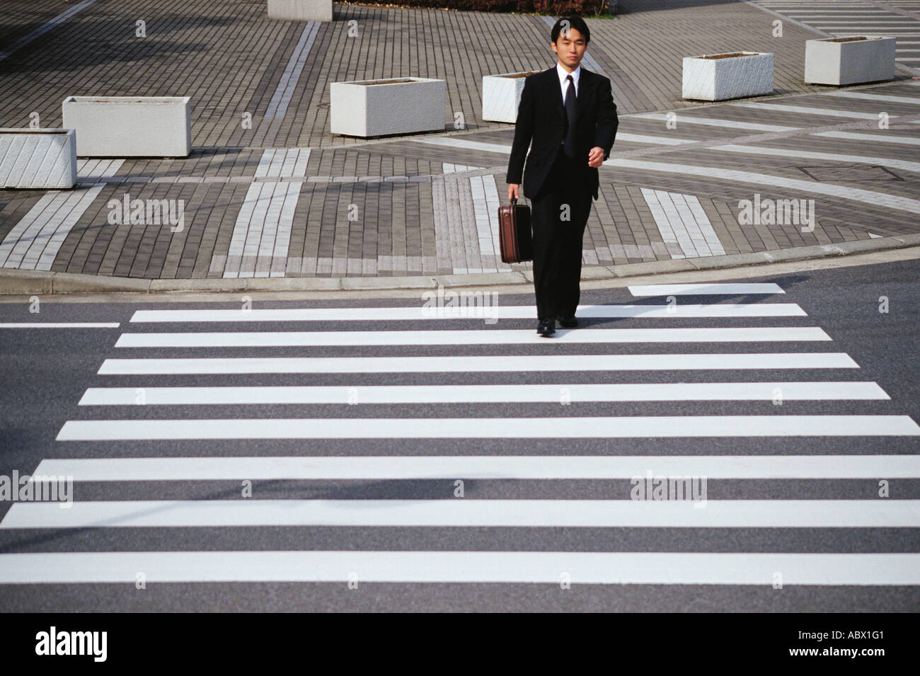 A man walking on zebra crossing Stock Photo - Alamy