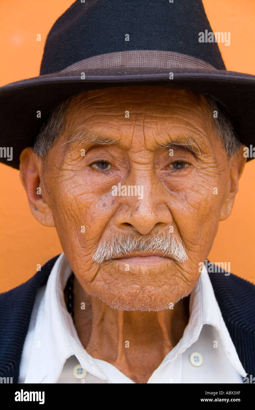 Local colorful old man with wrinkles and great eyes against bright wall ...