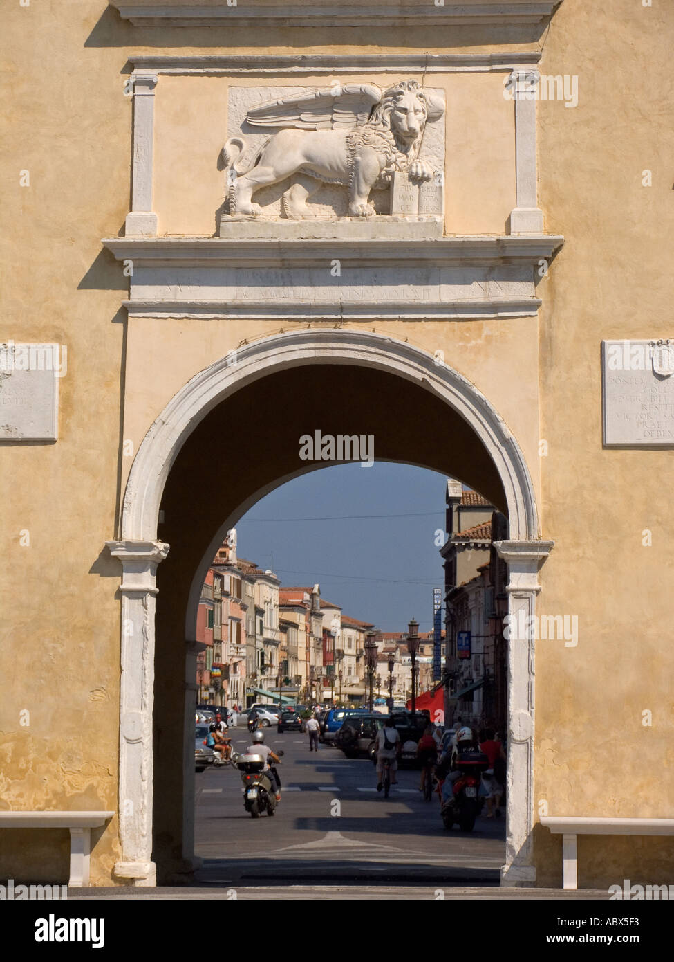 City entrance gate with Lion of St Mark frames main street of Chioggia ...