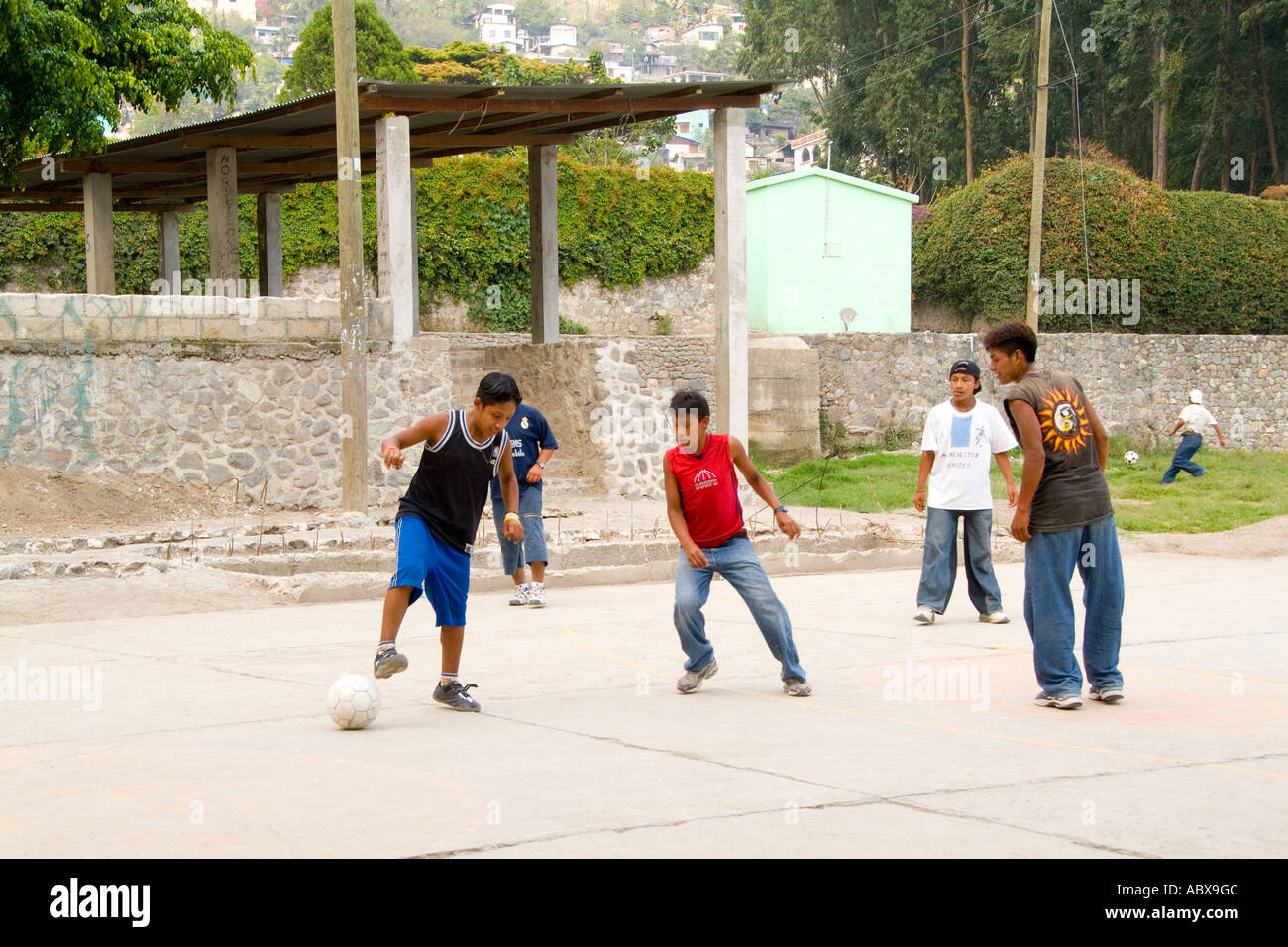 Boys playing soccer football on playground cement in San Antonio on ...