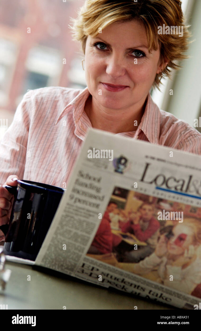 Woman reading newspaper Stock Photo - Alamy
