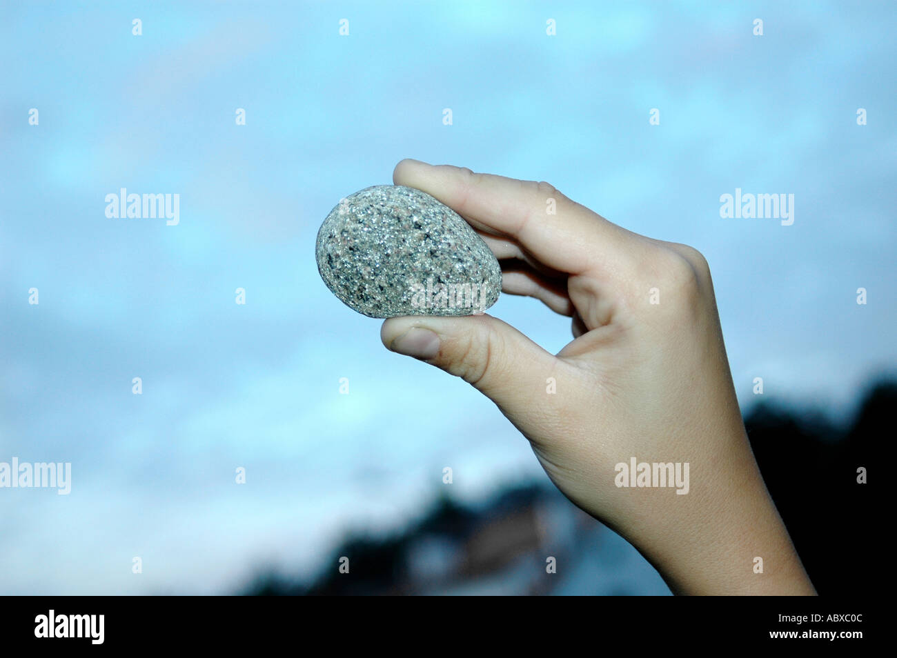 Hand holding stone talisman Stock Photo - Alamy