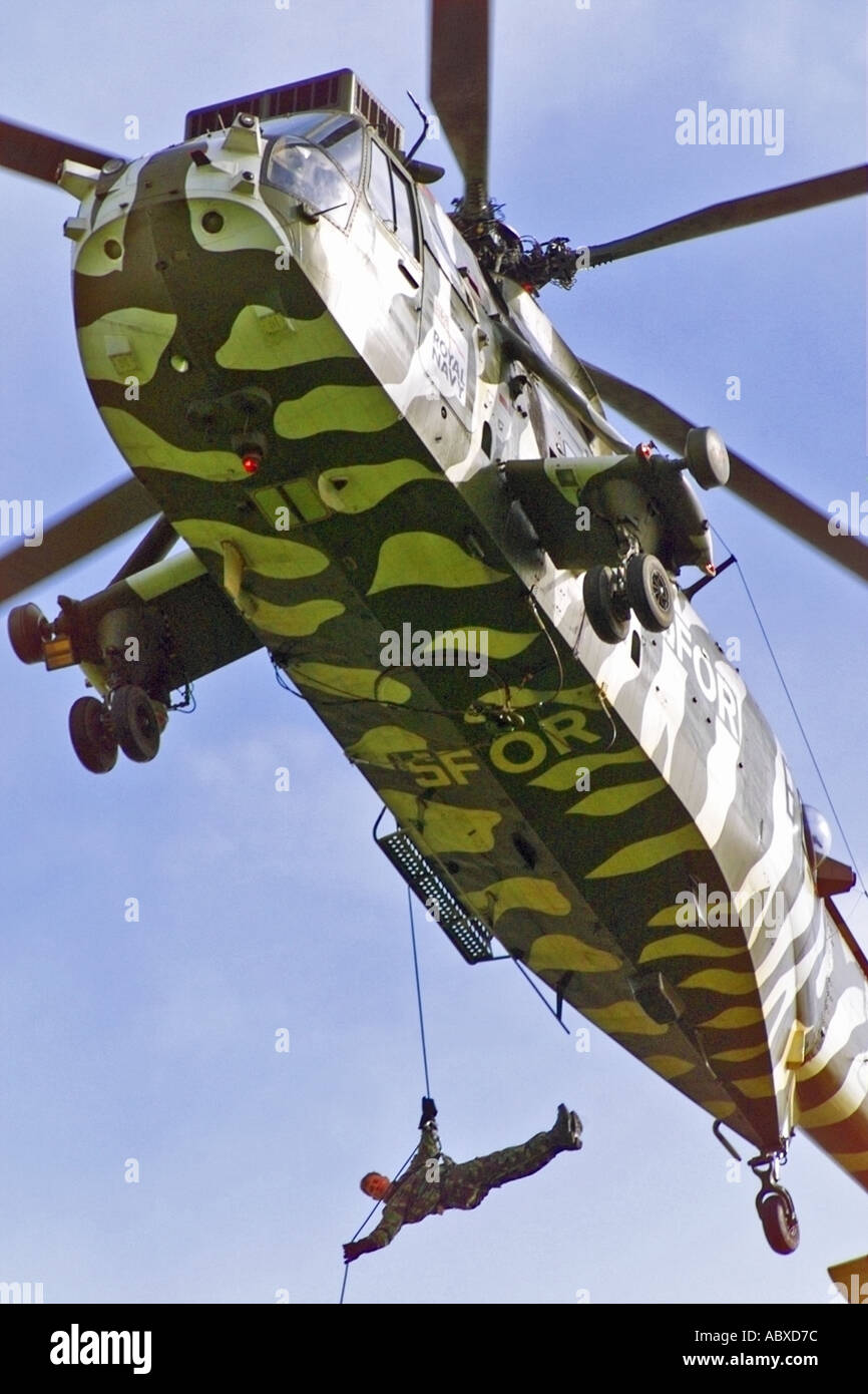 Soldier abseiling down rope from Royal Navy Sea King helicopter ...